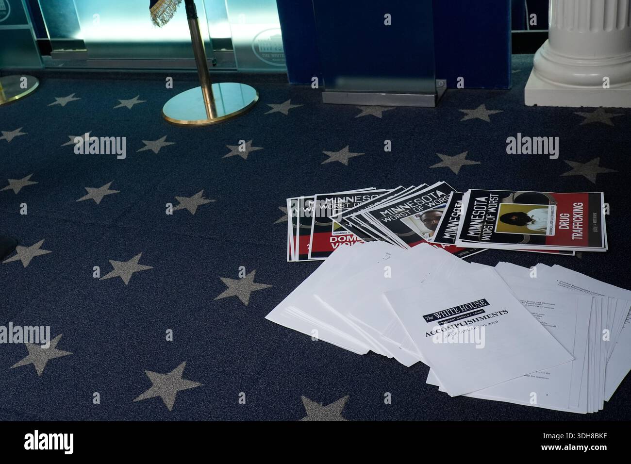 Documents lie on the briefing room floor as President Donald Trump ...