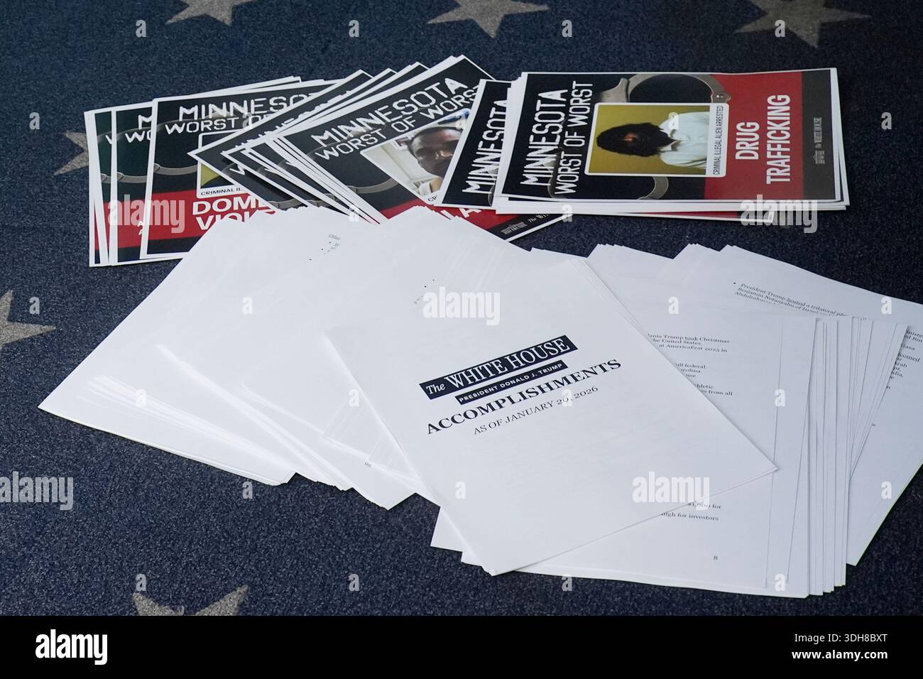 Documents lie on the briefing room floor as President Donald Trump ...