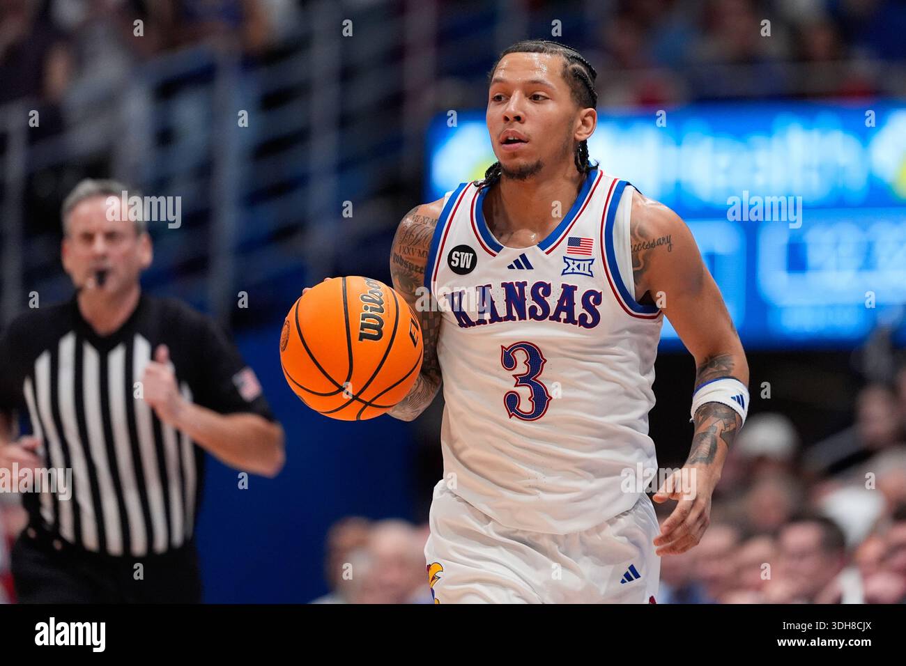 Kansas guard Tre White drives during the first half of an NCAA college ...