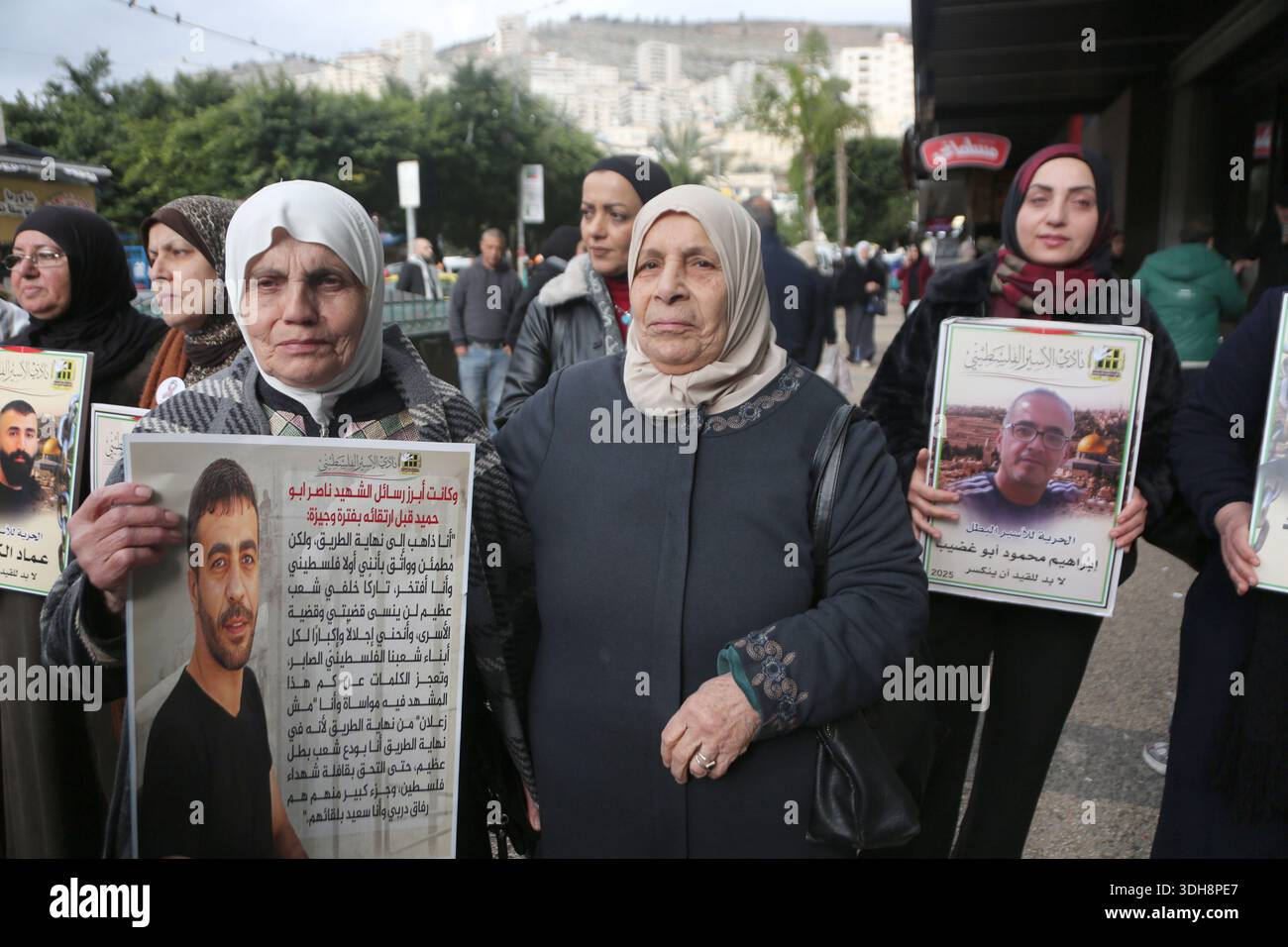 Palestinian women, hold up pictures of prisoned relatives in Israeli ...