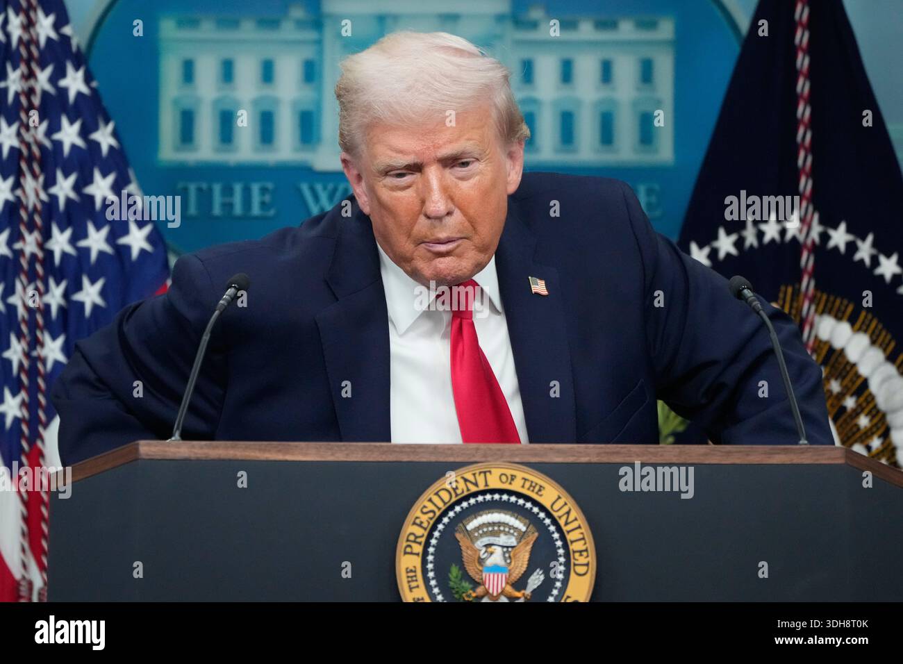 President Donald Trump listens to a question from a reporter during a ...