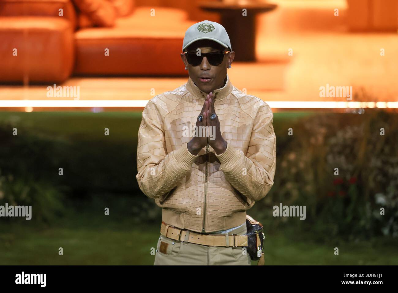 Designer Pharrell Williams accepts applause after the Louis Vuitton ...