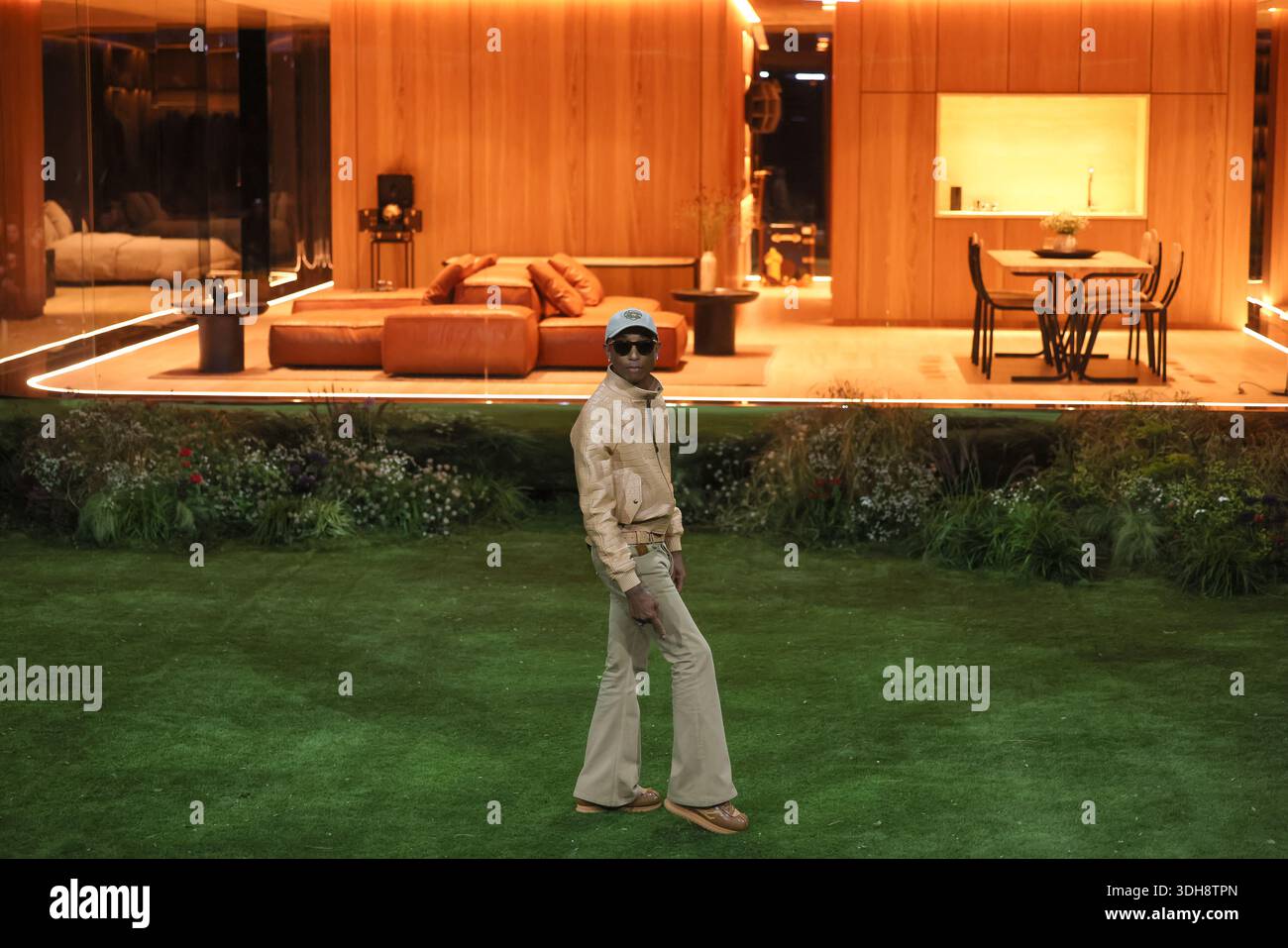 Designer Pharrell Williams accepts applause after the Louis Vuitton ...