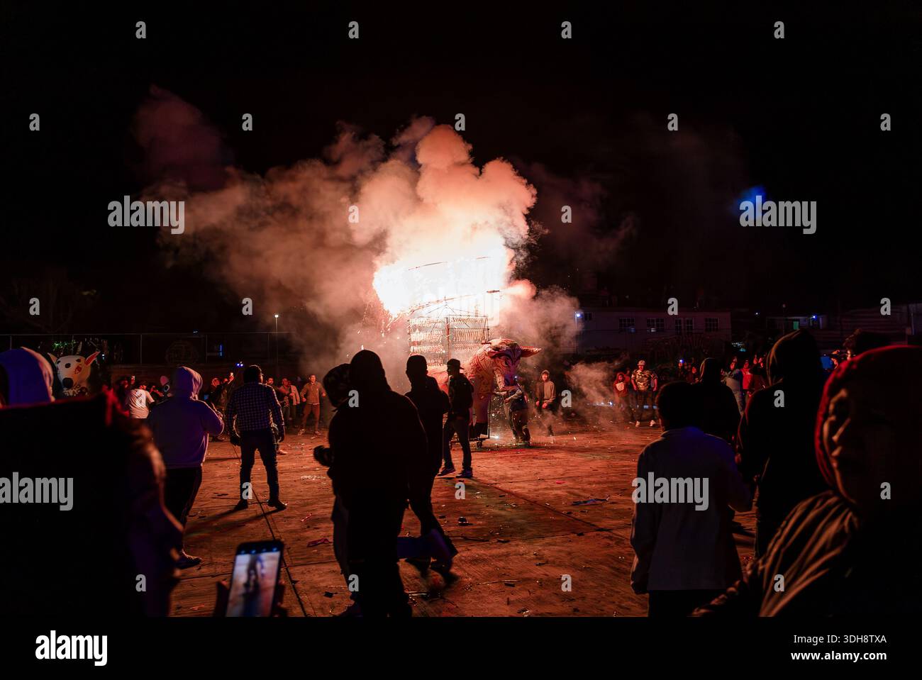 A pyrotechnic bull structure explodes with sparks and smoke during a ...