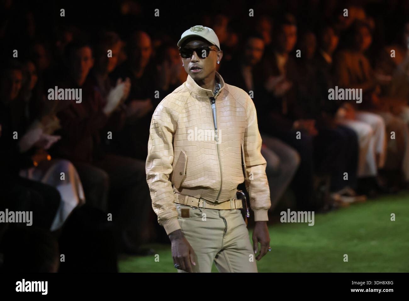 Designer Pharrell Williams accepts applause after the Louis Vuitton ...