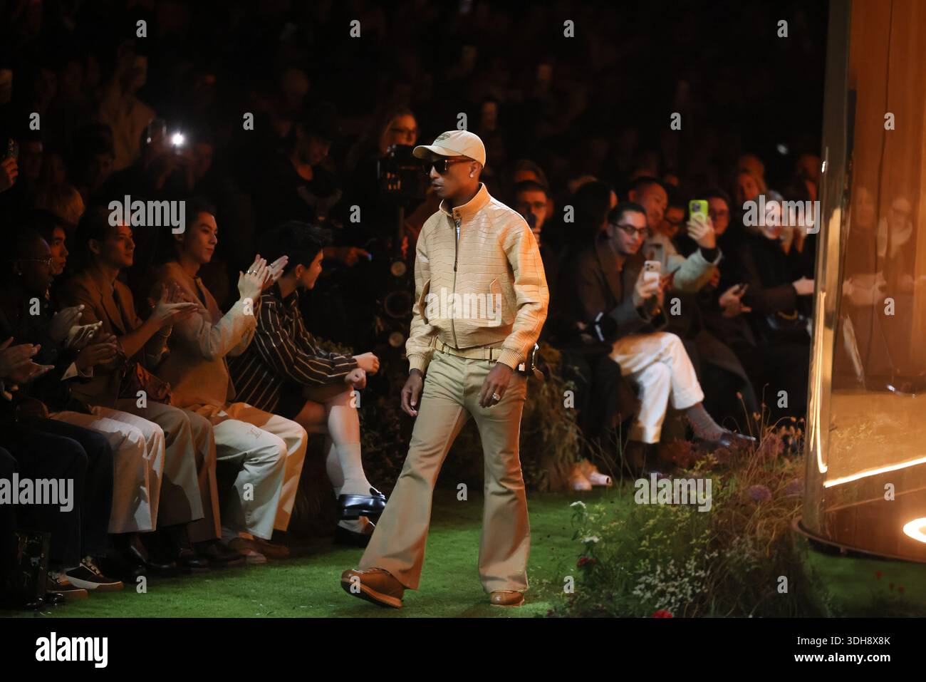 Designer Pharrell Williams accepts applause after the Louis Vuitton ...