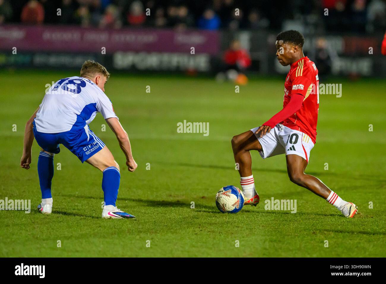 Gavin Kilkenny of Swindon Town FC tries to tackle Kelly Nmai of Salford ...