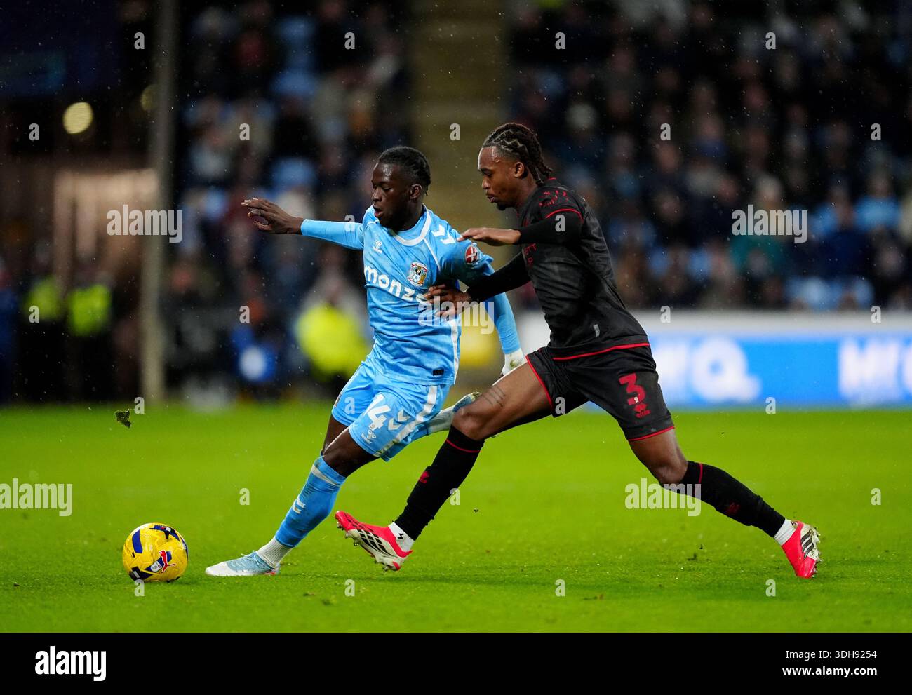 Coventry City's Romain Esse (left) and Millwall's Zak Sturge (right ...