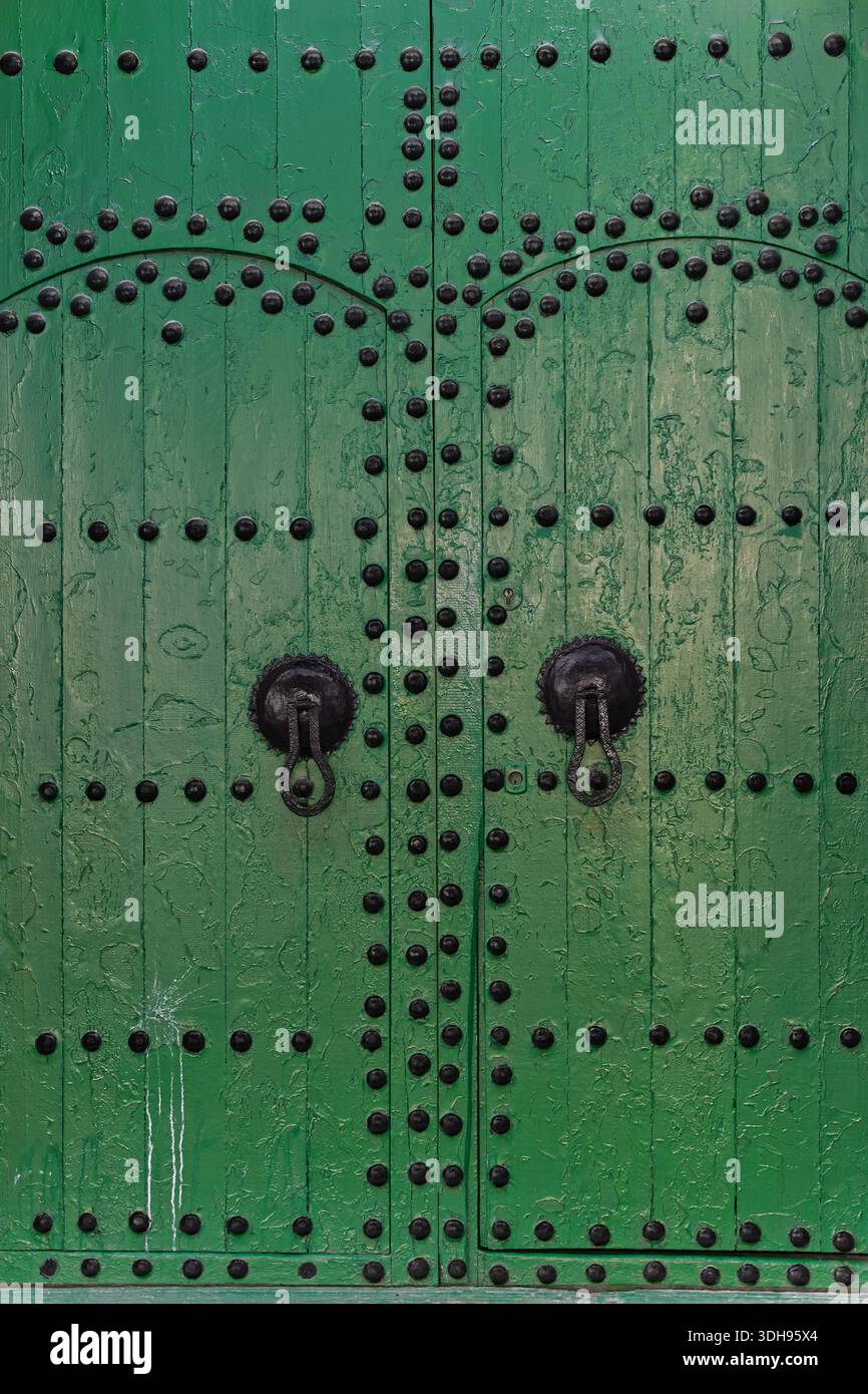 073 Studded door, evenly painted over chipped wood, of the Al-Qadiriya ...