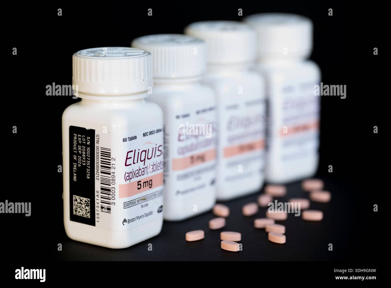Eliquis bottles on black background with some out of focus. Eliquis is ...