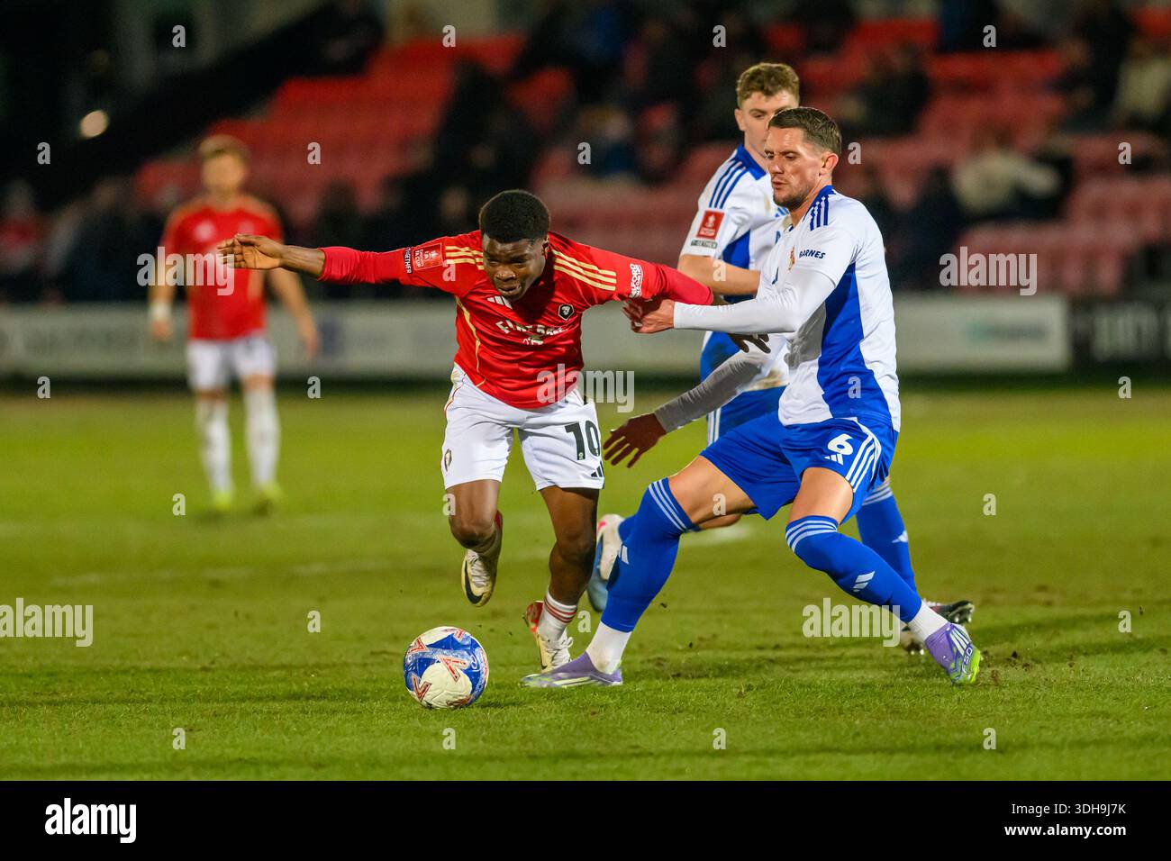 James Ball of Swindon Town FC tackles Kelly Nmai of Salford City FC ...