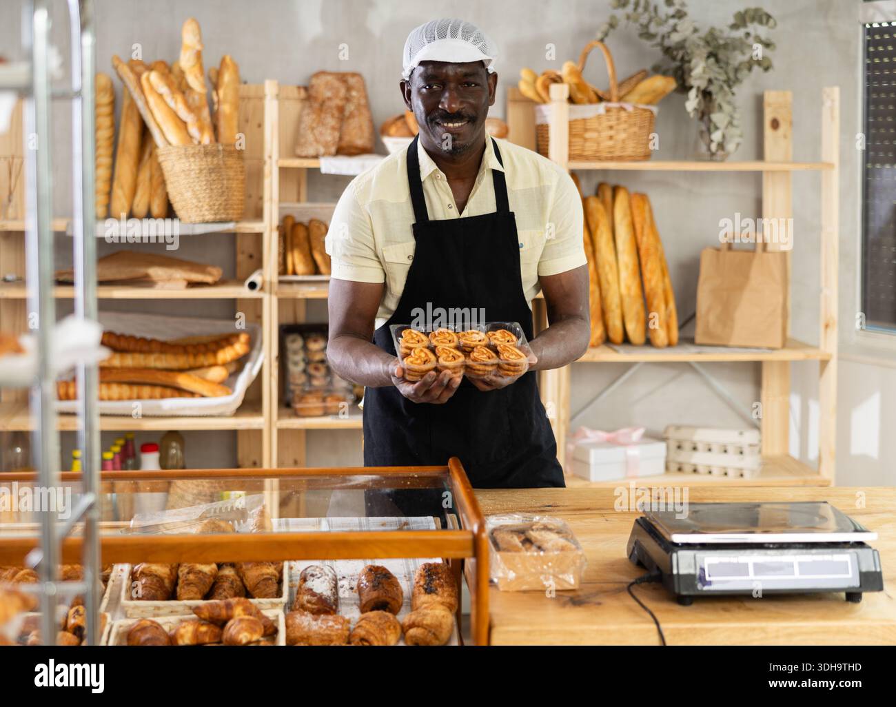 Baker carrying tray cookies hi-res stock photography and images - Alamy