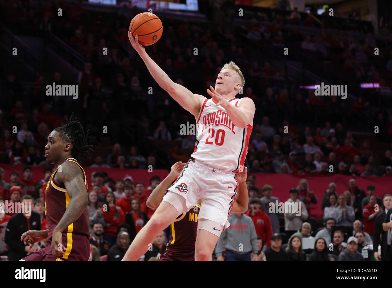 Ohio State forward Colin White, shoots behind Minnesota guard Langston ...
