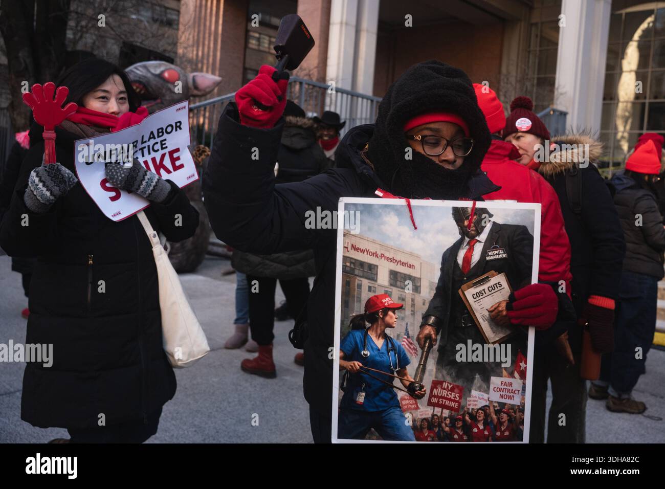 A nurse with a sign of a modern depiction of David versus Goliath ...