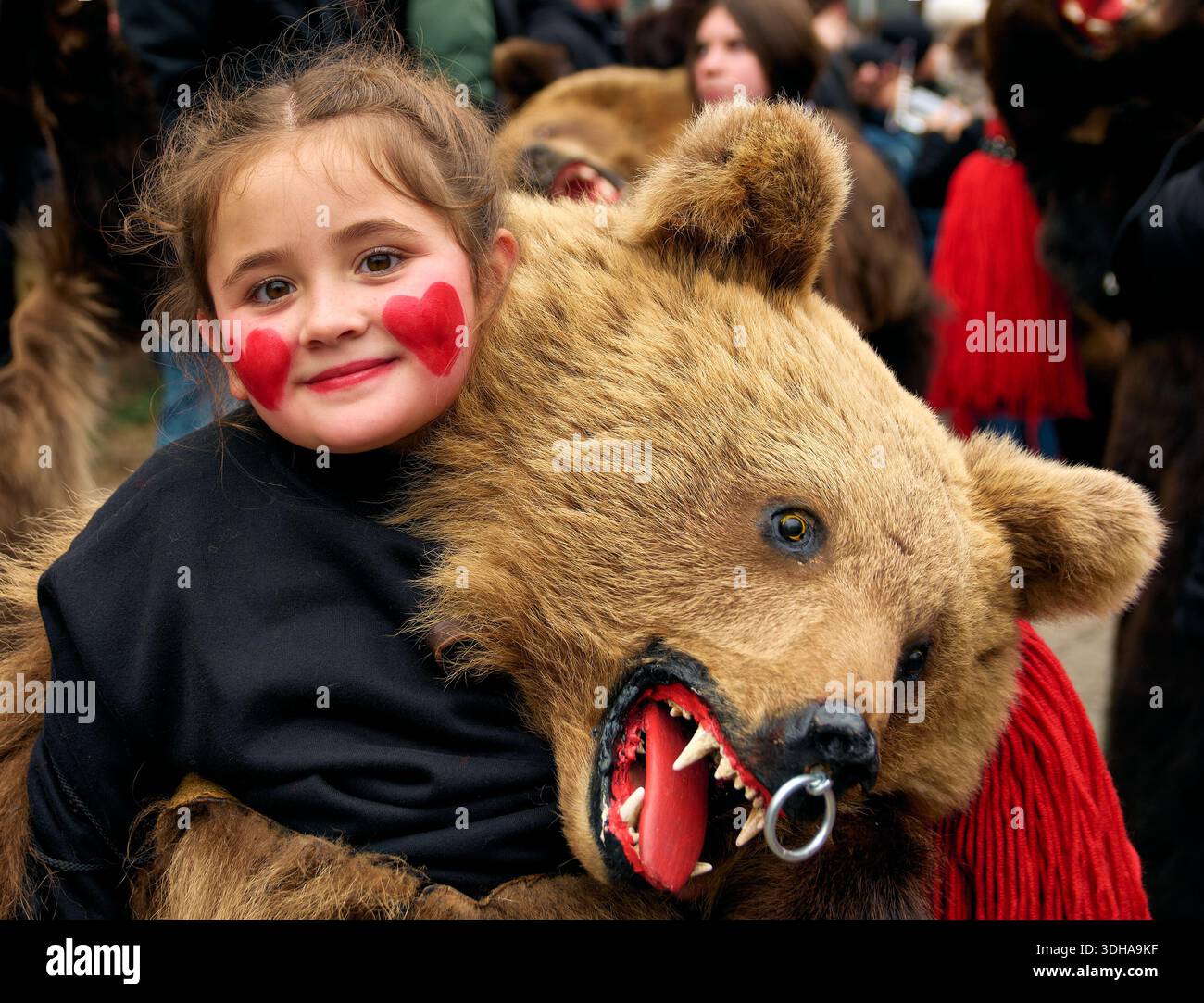 People dancing dressed in bearskin and folk costumes at the Comanesti ...