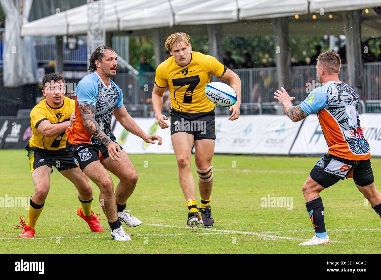 Rugby players in action during a competitive match in Singapore, with a ...