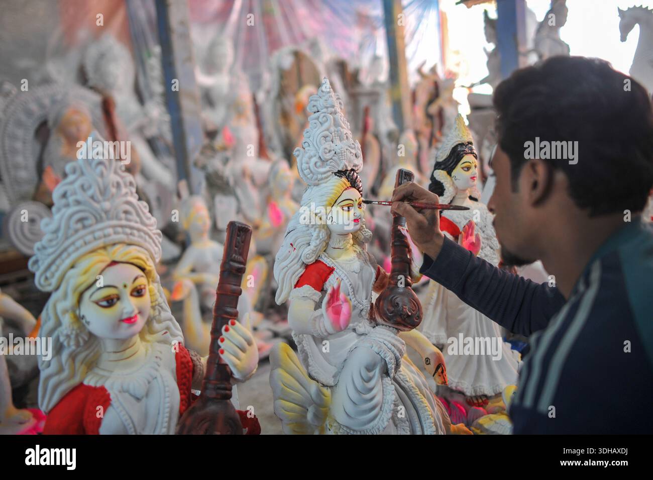 Idol artists painting idols of Goddess Saraswati as preparations ...