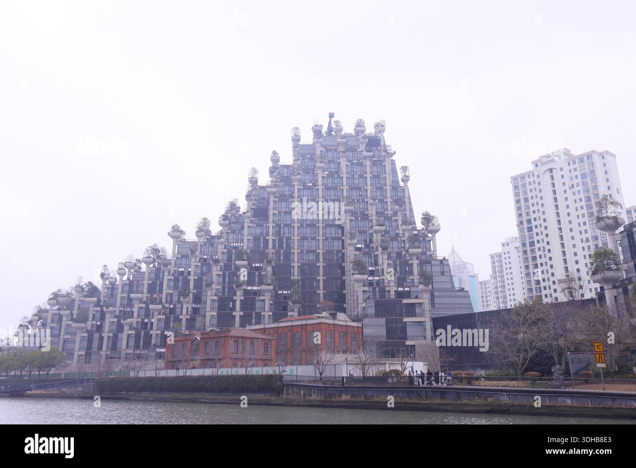 The uniquely shaped building by Suzhou Creek attracts visitors in ...