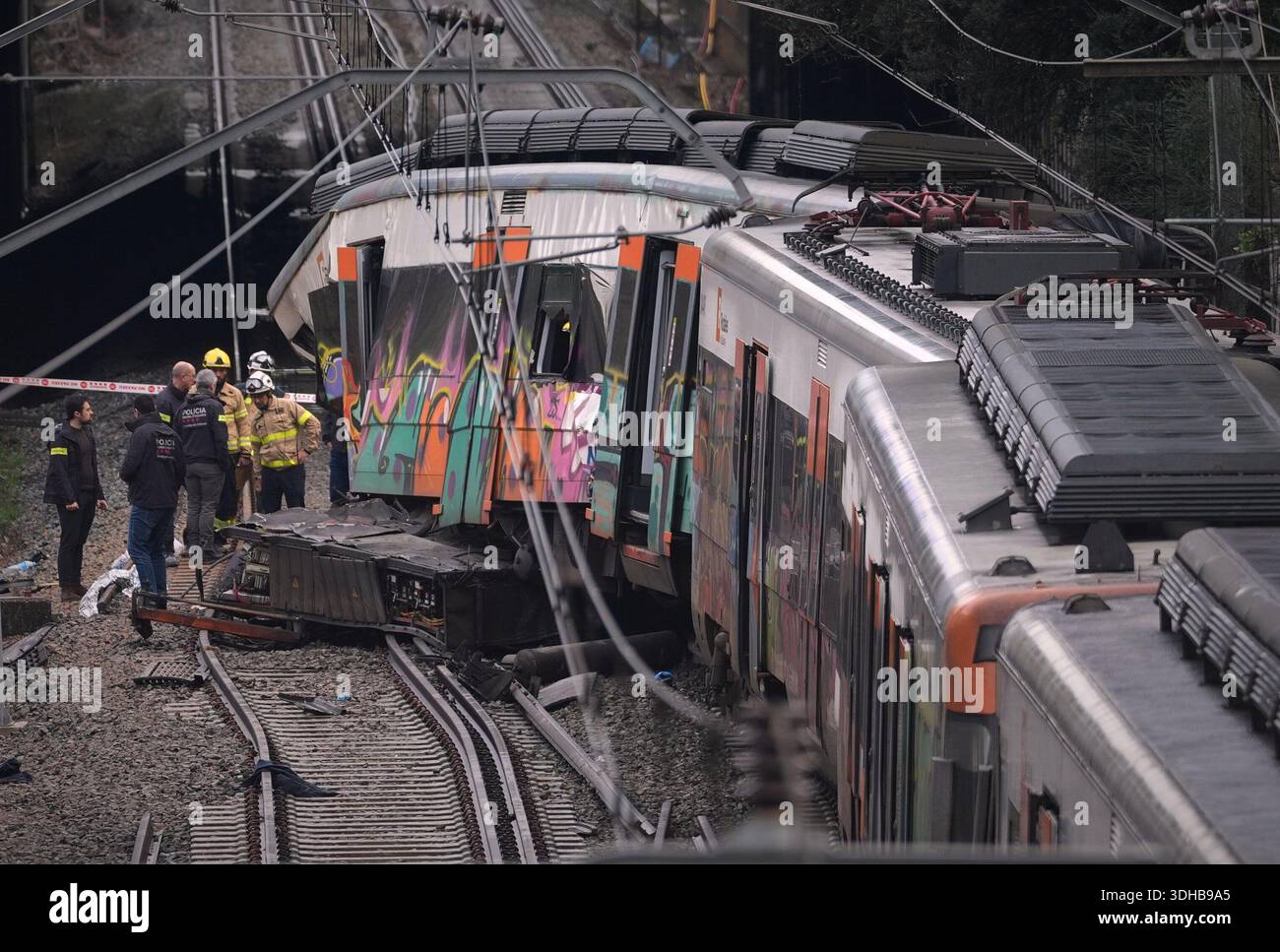 Police officers inspect the damage after a commuter train derailed as a ...