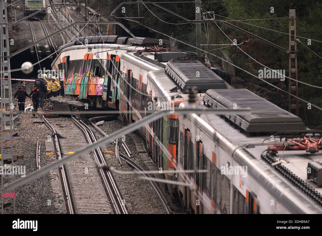 Police officers inspect the damage after a commuter train derailed as a ...
