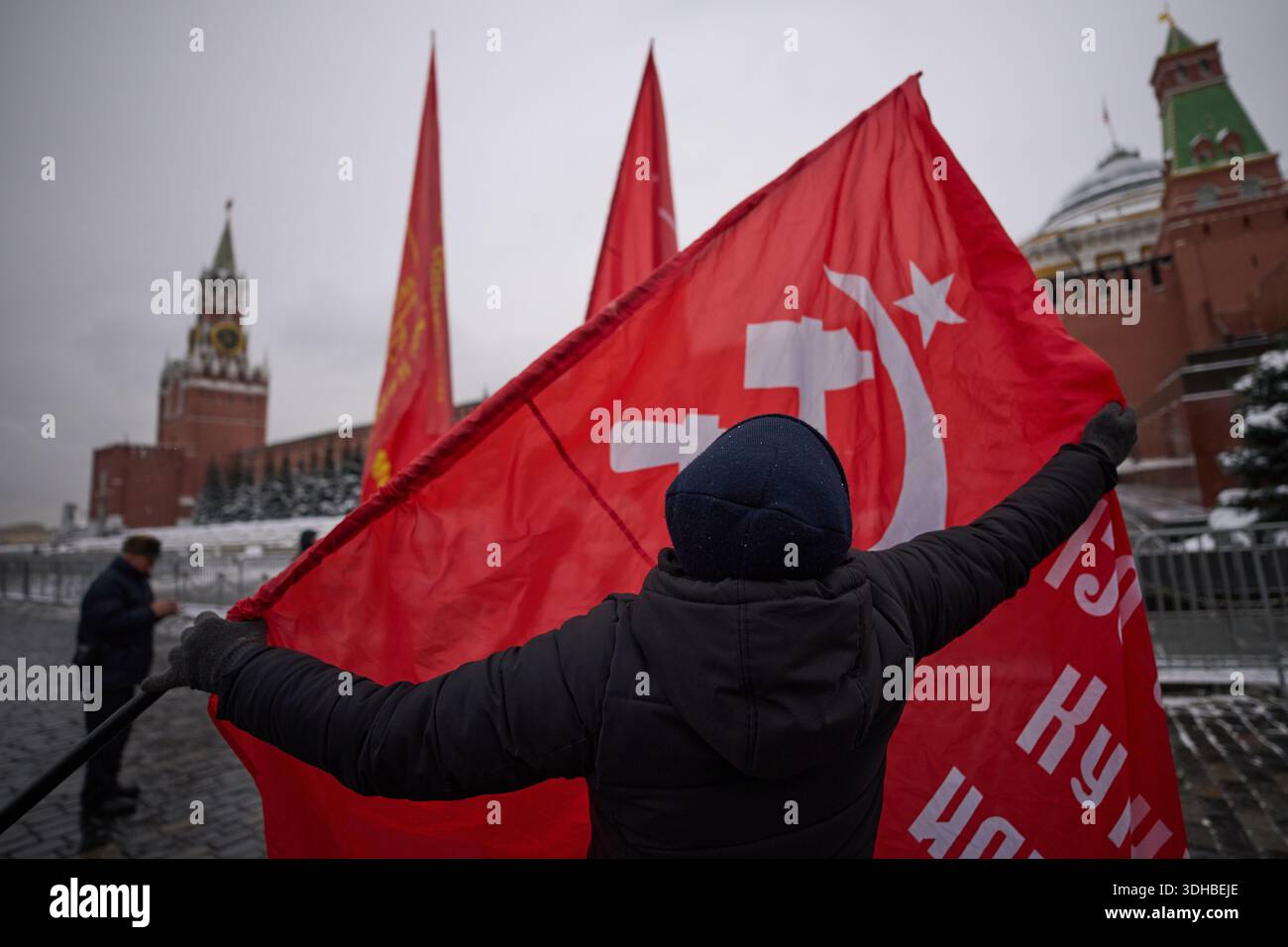A Russian Communist supporter prepares a red flags on Red Square in ...
