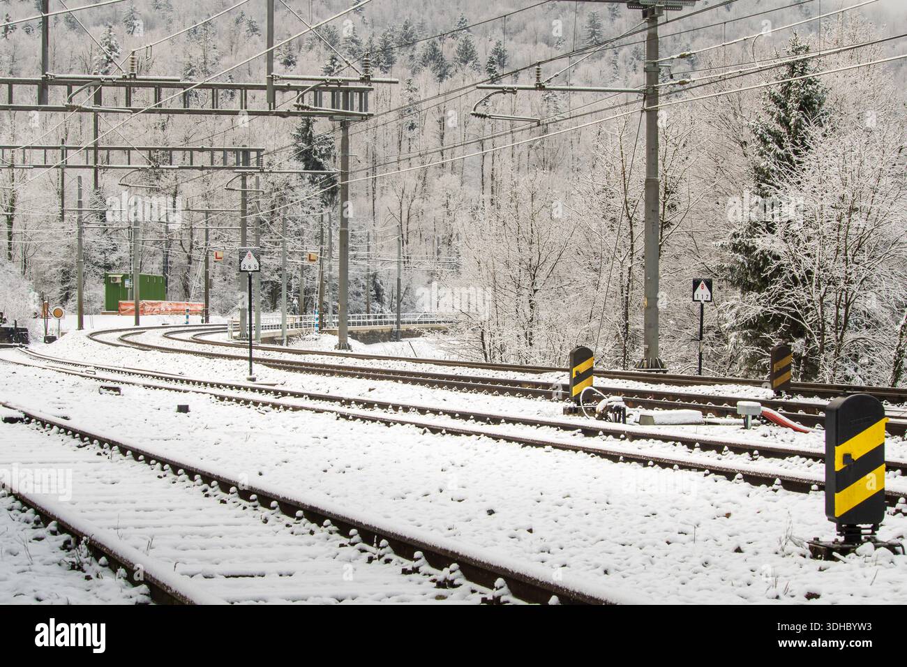 winter scene featuring multiple railway tracks covered in fresh snow ...