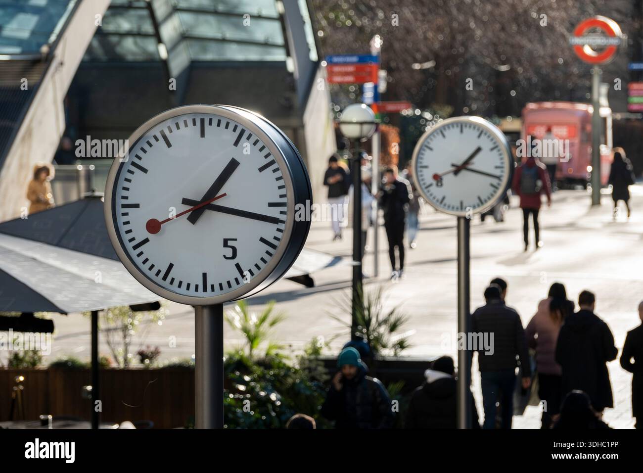 City workers walk under Six Public Clocks, a sculpture by Konstantin ...