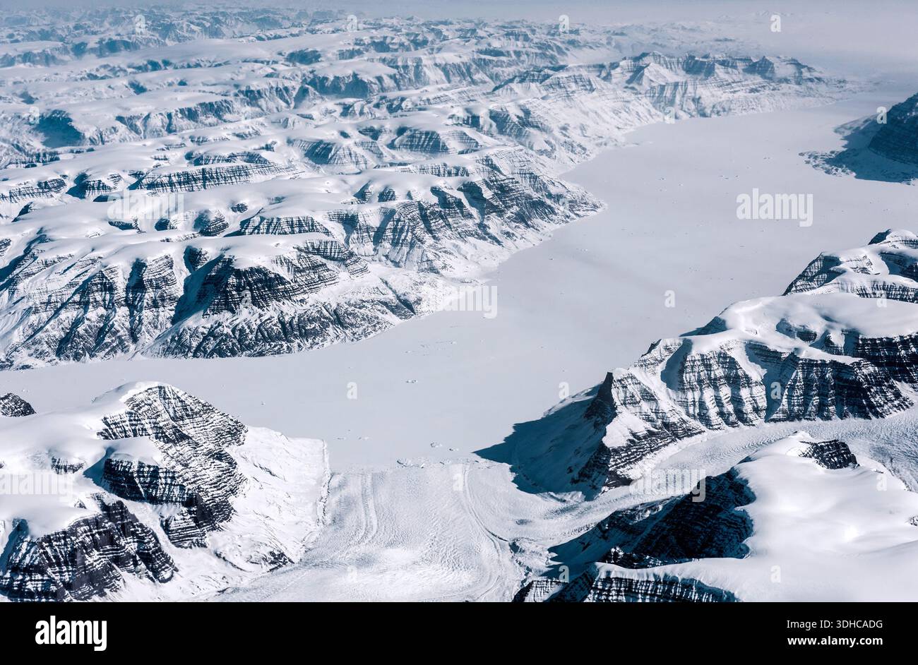 Aerial view of Arctic glacier and snowy mountains in Greenland polar ...