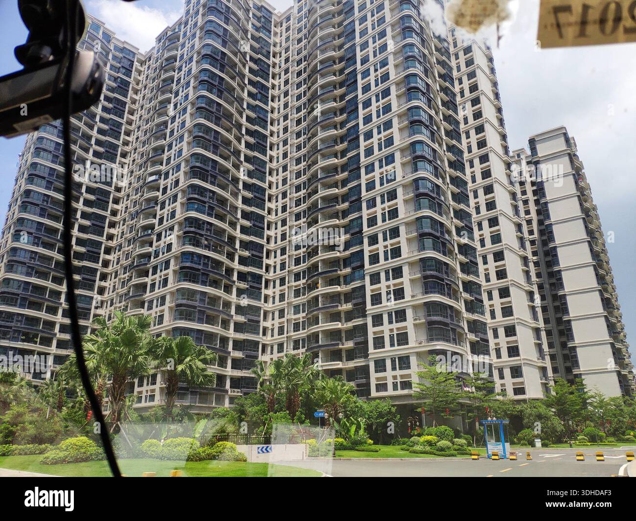 Modern High-Rise Apartment Complex with Glass Facades and Green ...