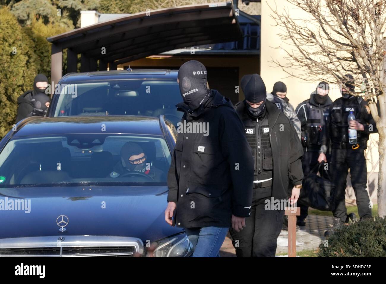 21 January 2026, Brandenburg, Königs Wusterhausen: Masked officers from ...