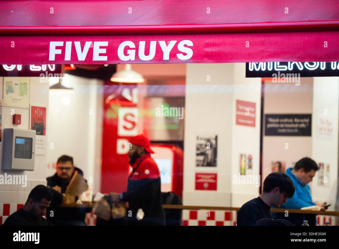 A Five Guys logo on a storefront in Bayswater, west London. Picture ...
