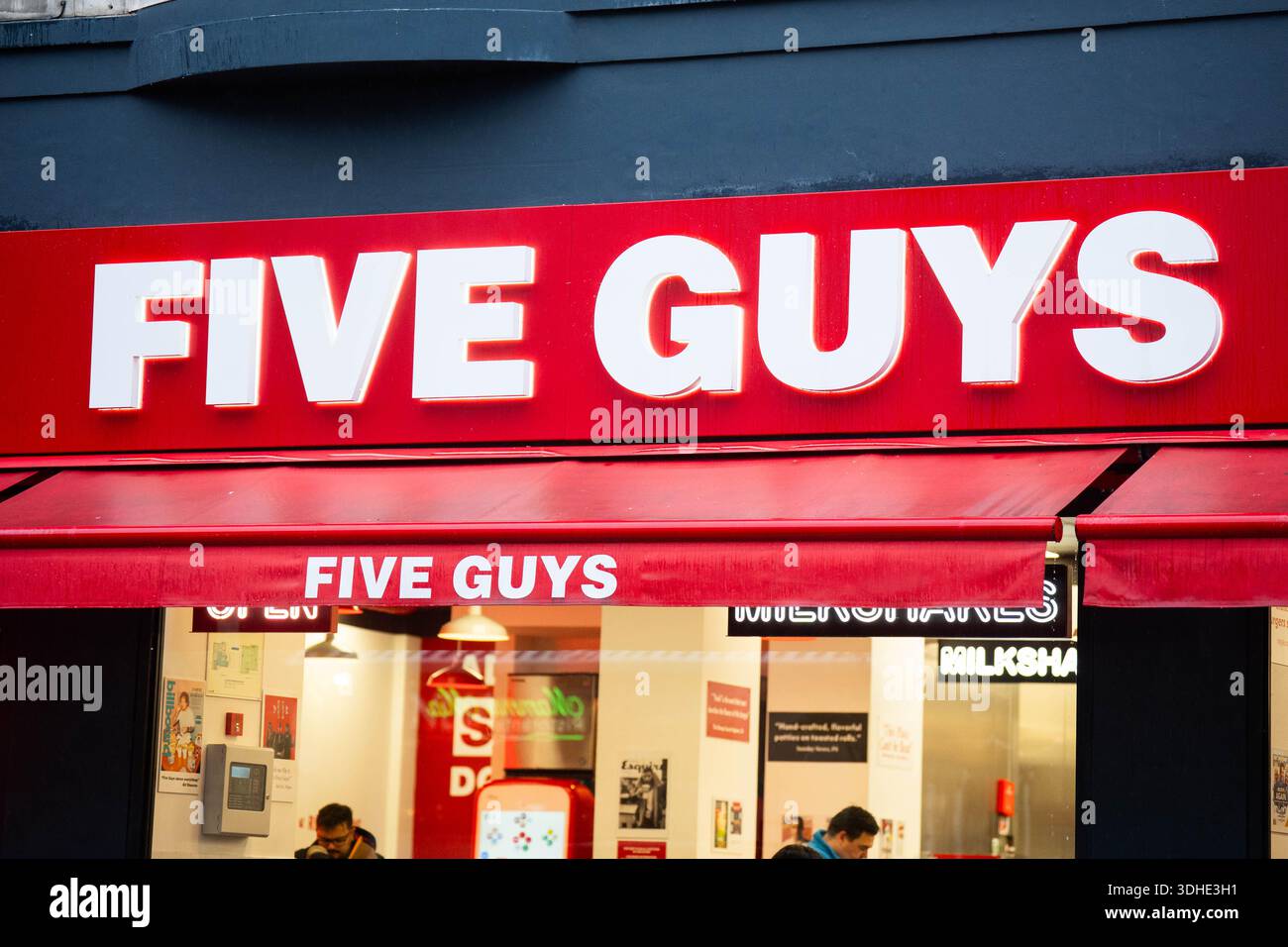 A Five Guys logo on a storefront in Bayswater, west London. Picture ...