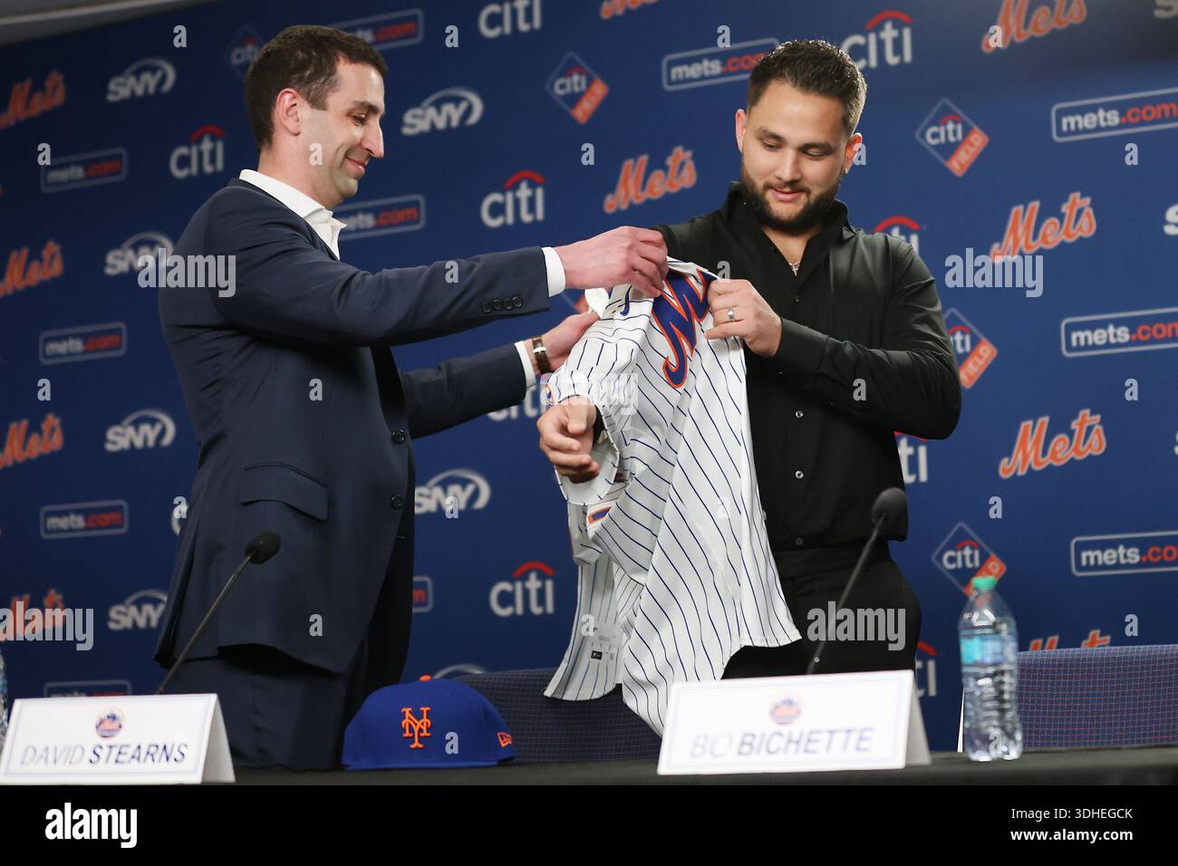 Bo Bichette, right, puts on his jersey with David Stearns, President of ...