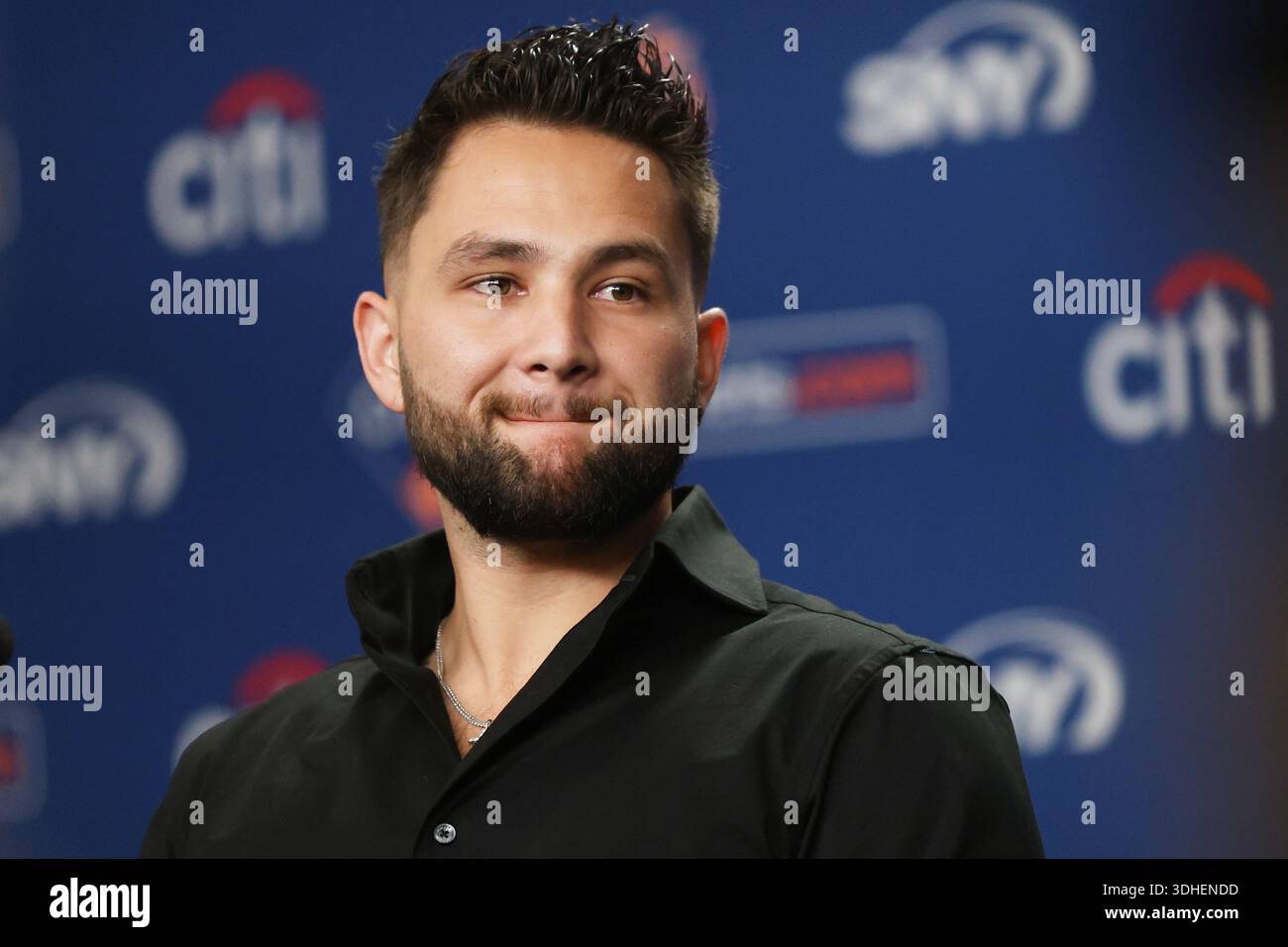 Bo Bichette listens to remarks during his introductory press conference ...