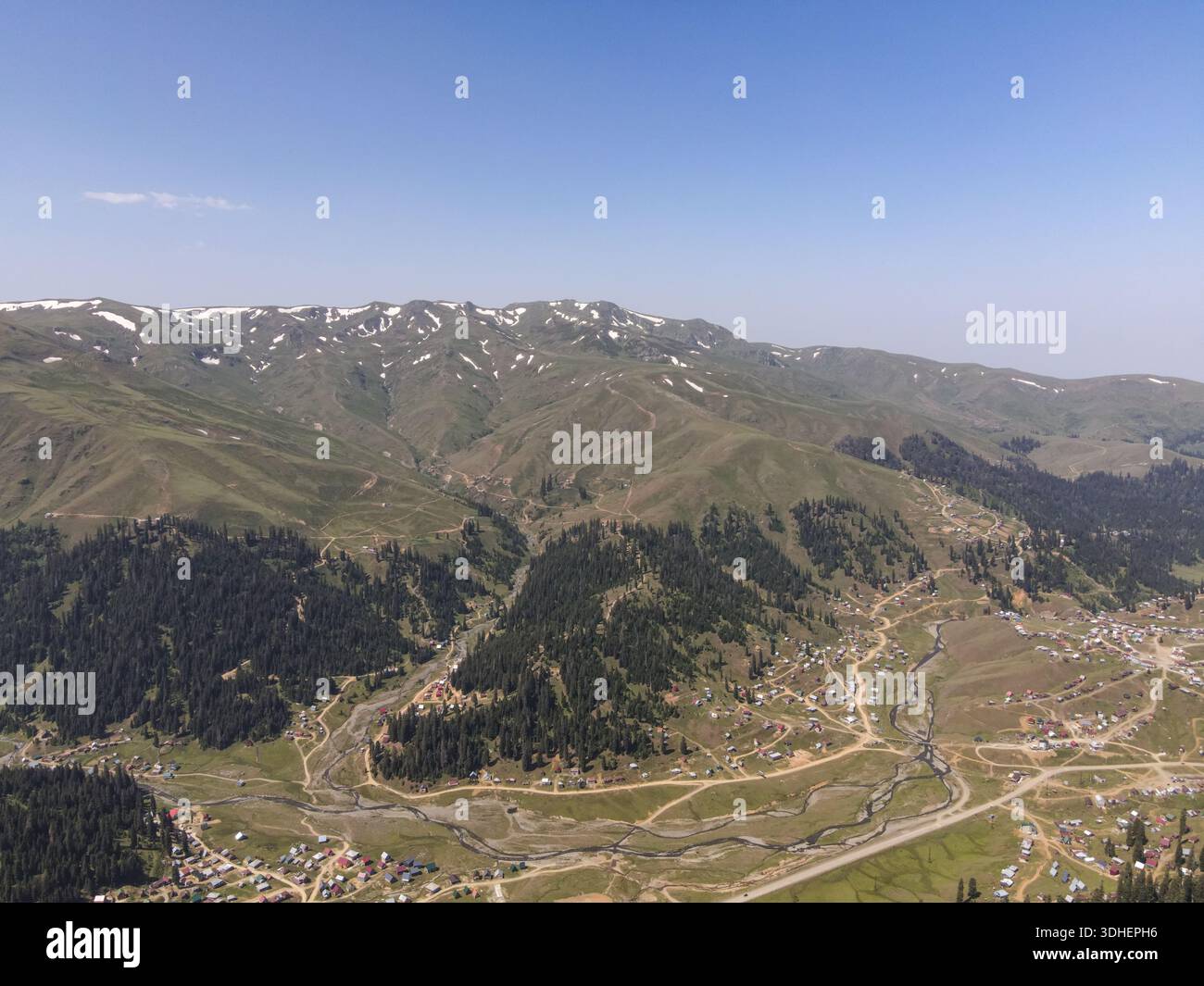 Aerial view of a Caucasus valley in Georgia shows villages, conifer ...