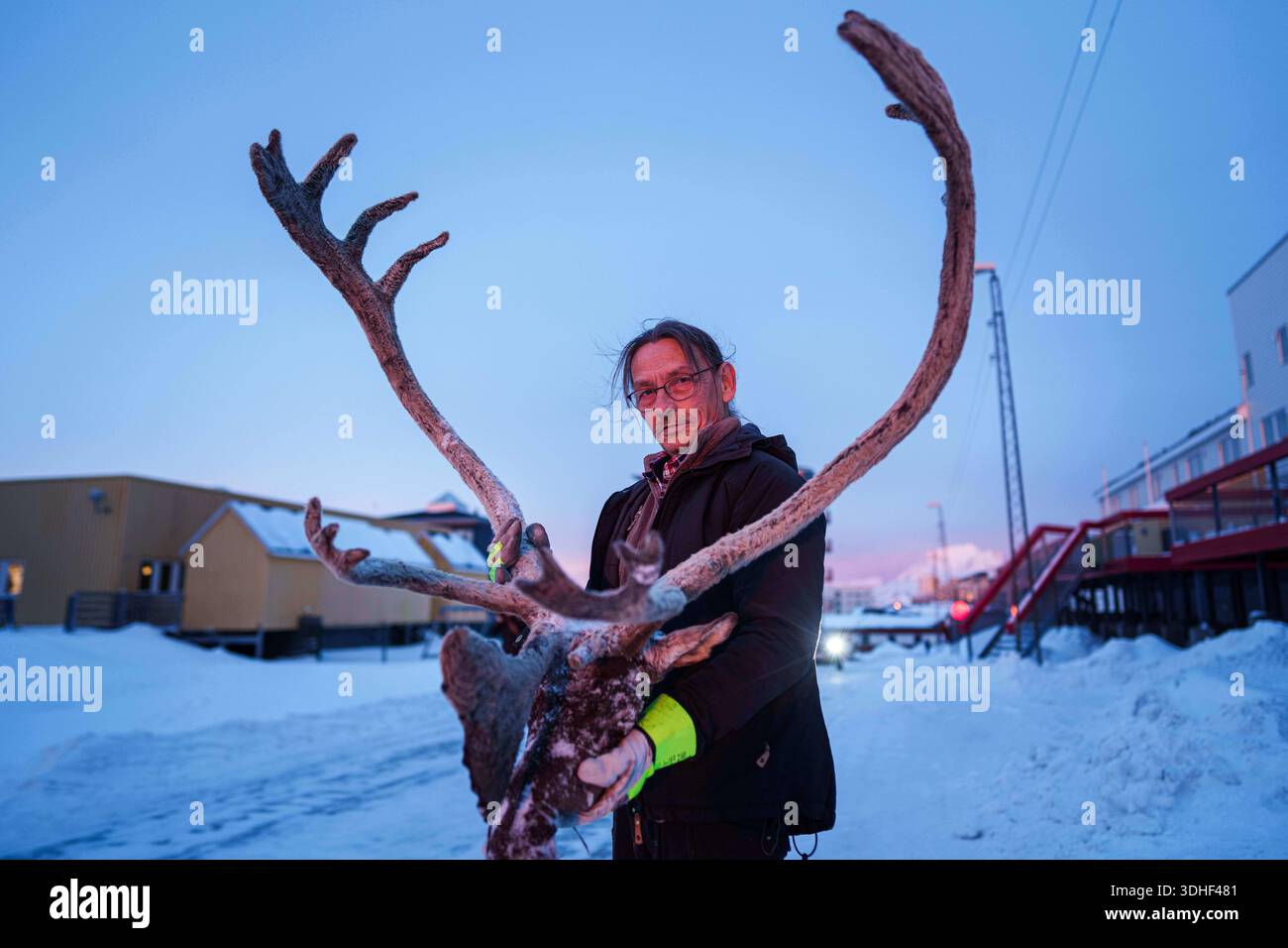 John Hansen, 61, holds a reindeer's head with antlers in Nuuk ...