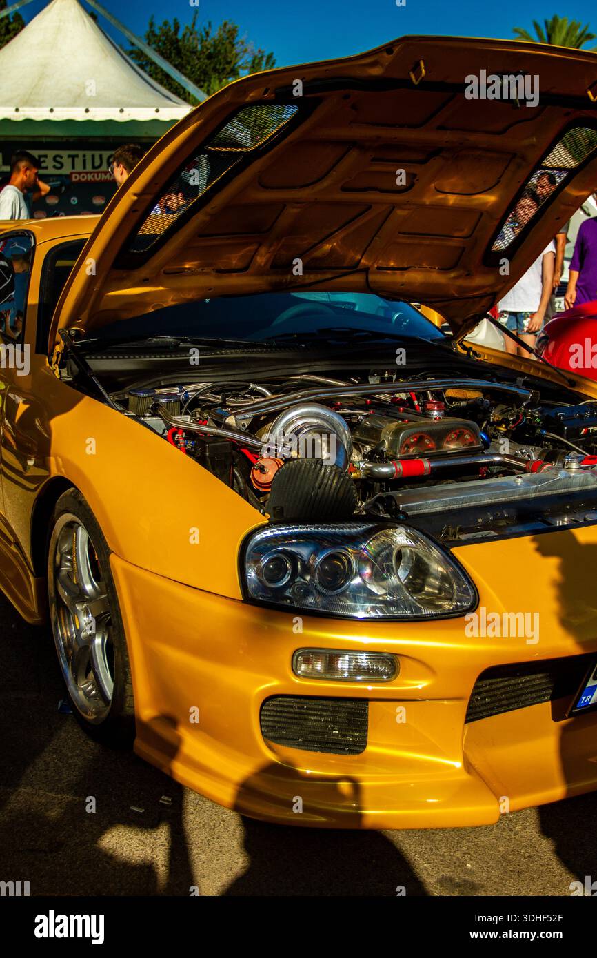 Vibrant yellow Toyota Supra MK4 on display at a car show. Iconic JDM ...
