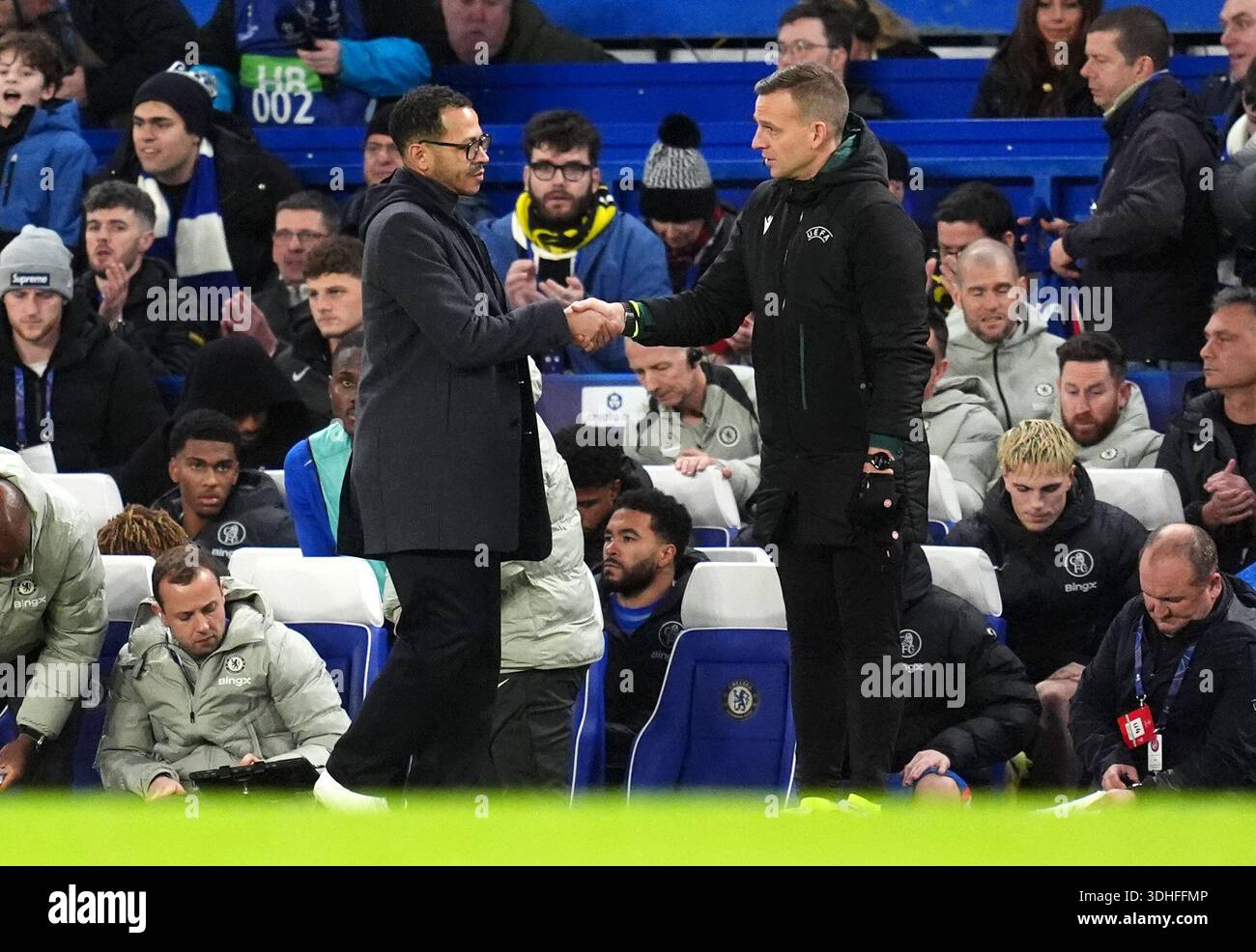 Chelsea manager Liam Rosenior (left) shake hands with fourth official ...