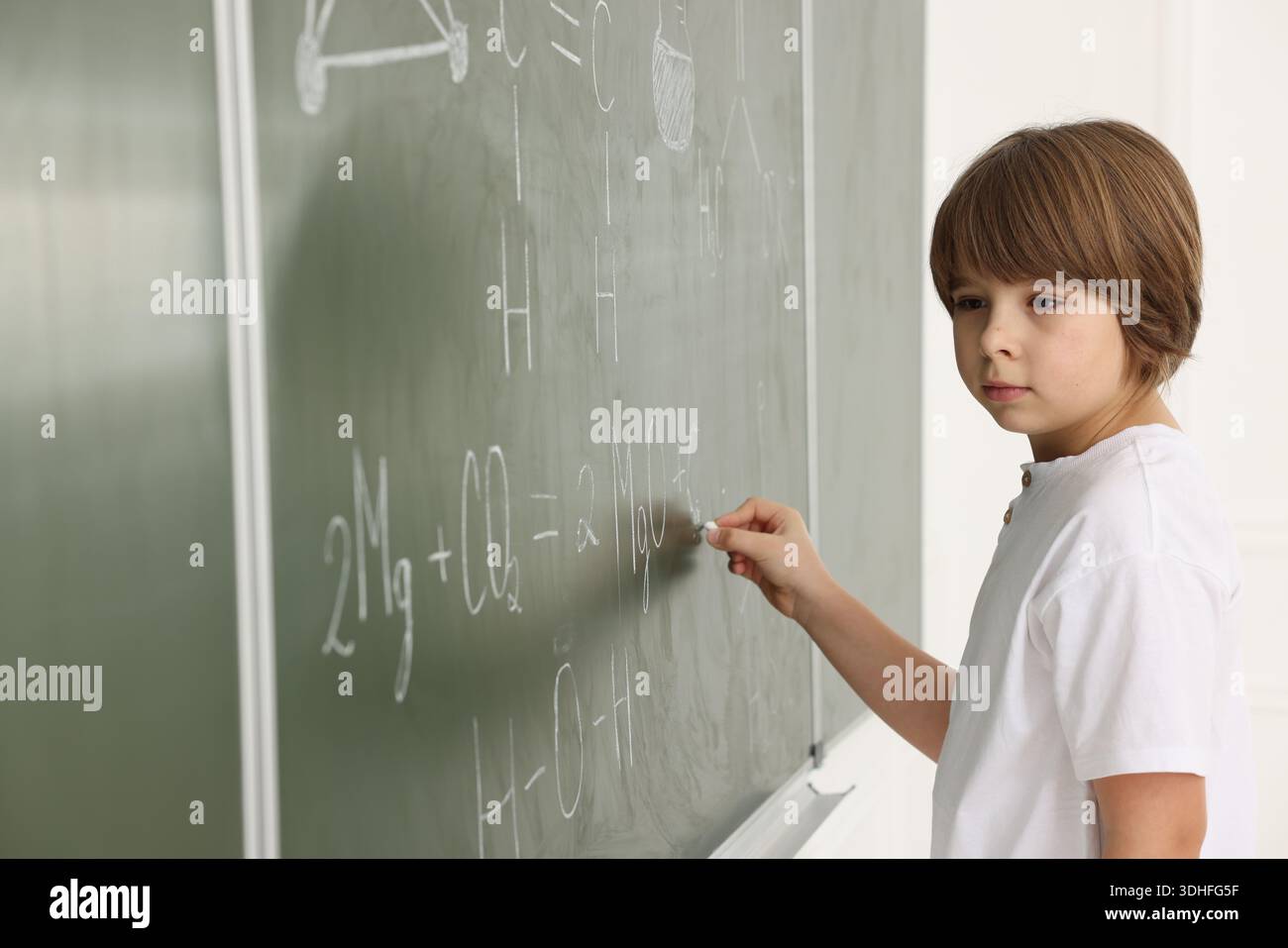 Schoolboy writing chemical formula hi-res stock photography and images ...