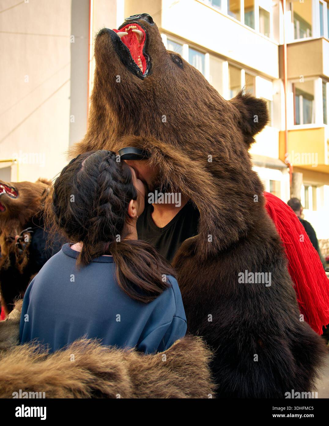 People dancing dressed in bearskin and folk costumes at the Comanesti ...