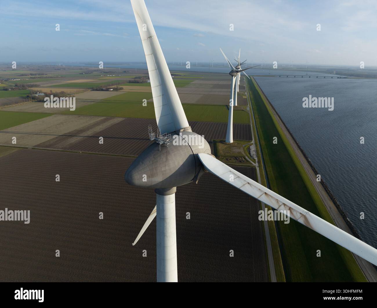Wind energy production in agricultural landscape overlooking water ...