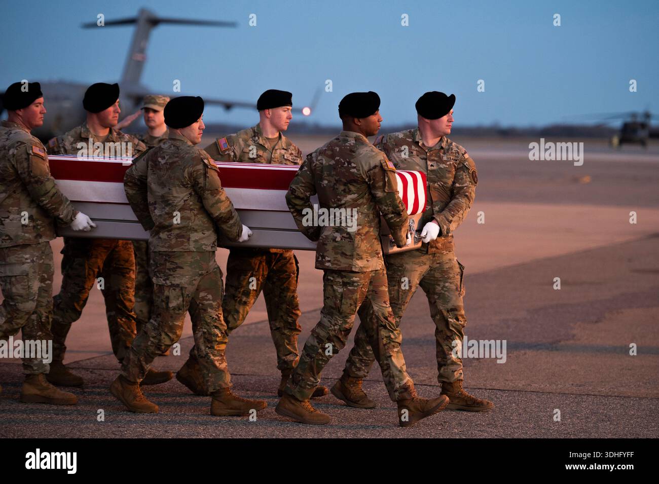 An Army carry team moves a transfer case containing the remains of Army ...