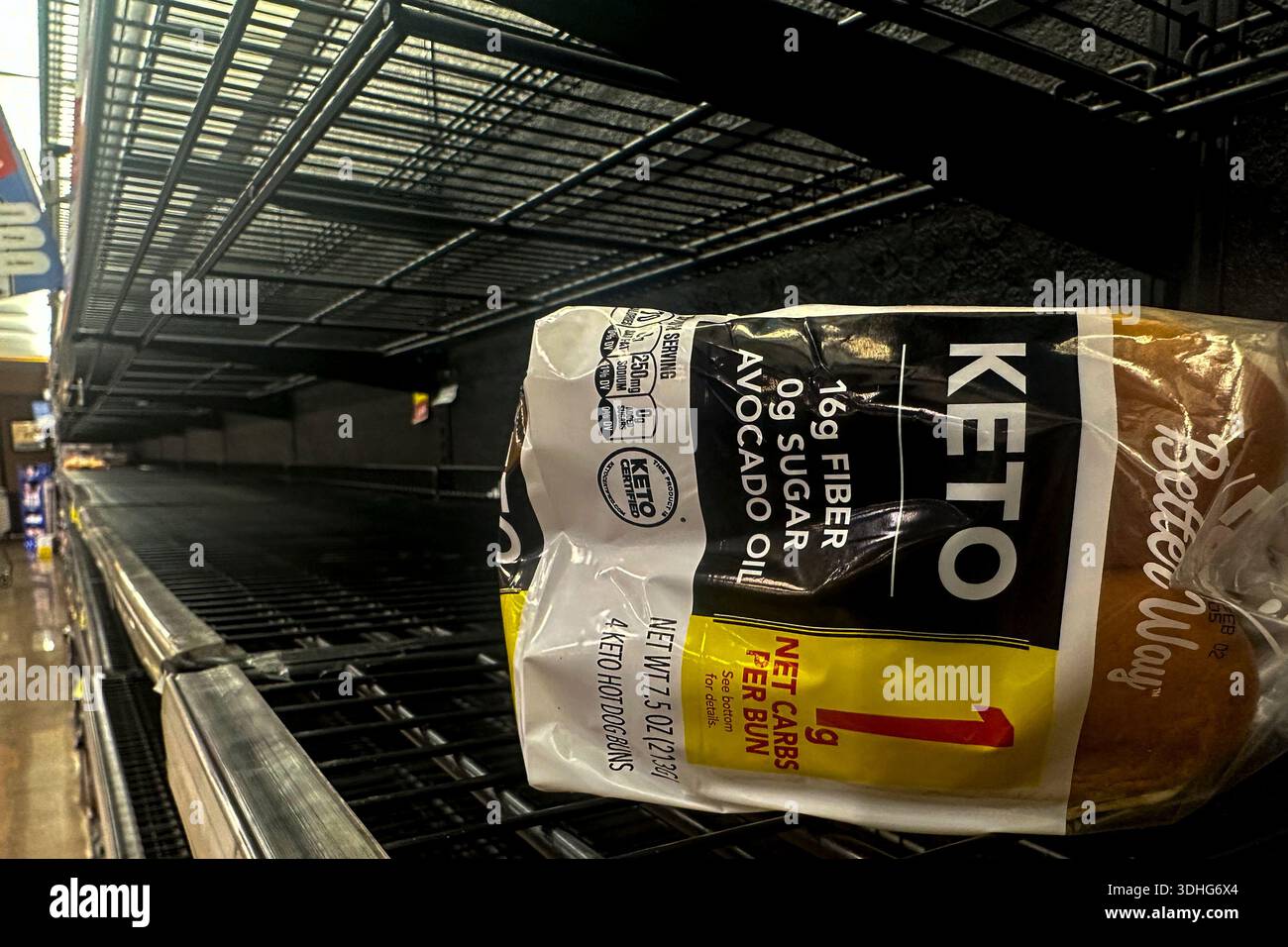 A loaf of bread sits on empty shelves in the bread isle in grocery ...