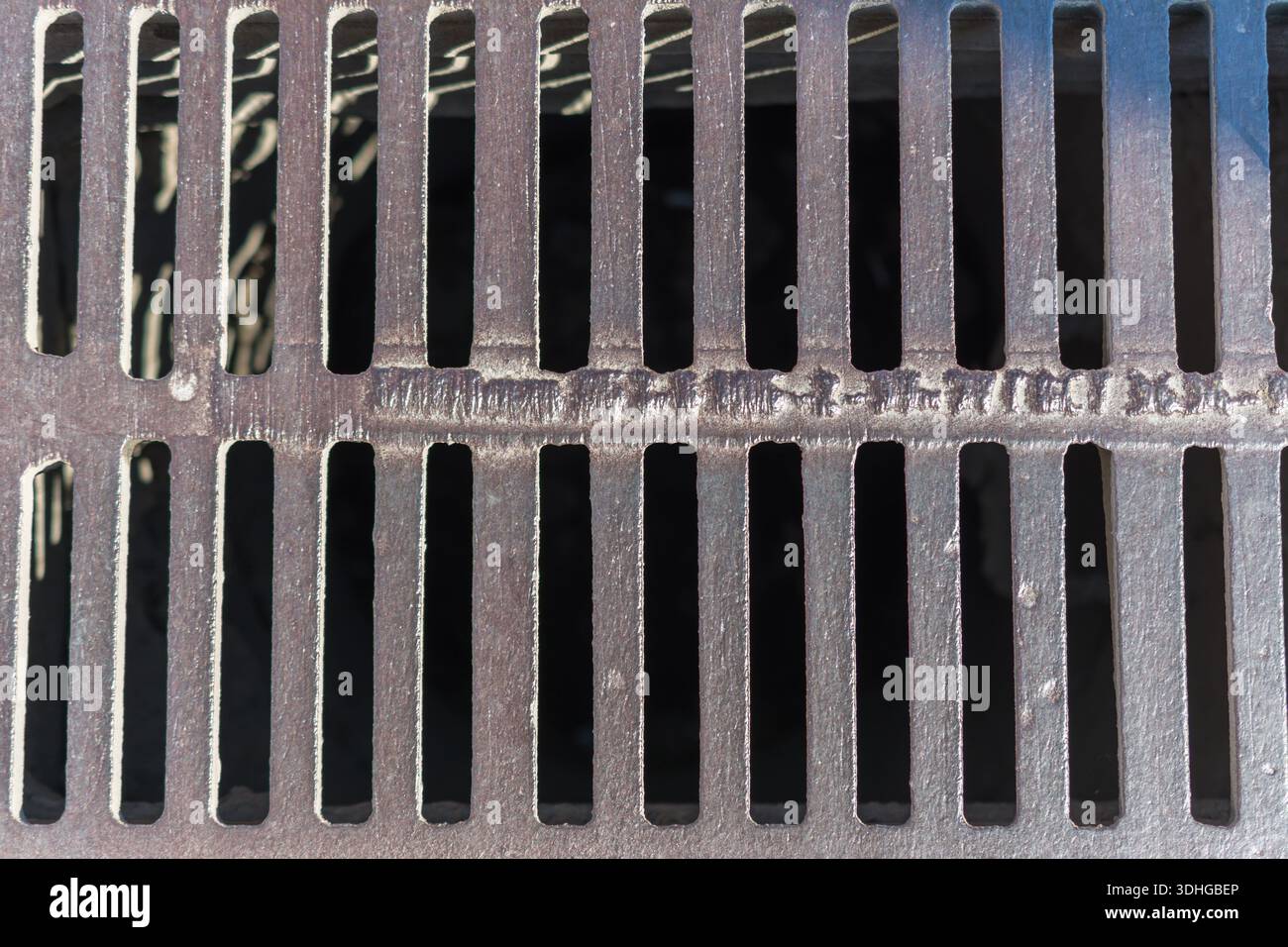 Front view of steel drainage grating of the asphalt road. Steel grate ...