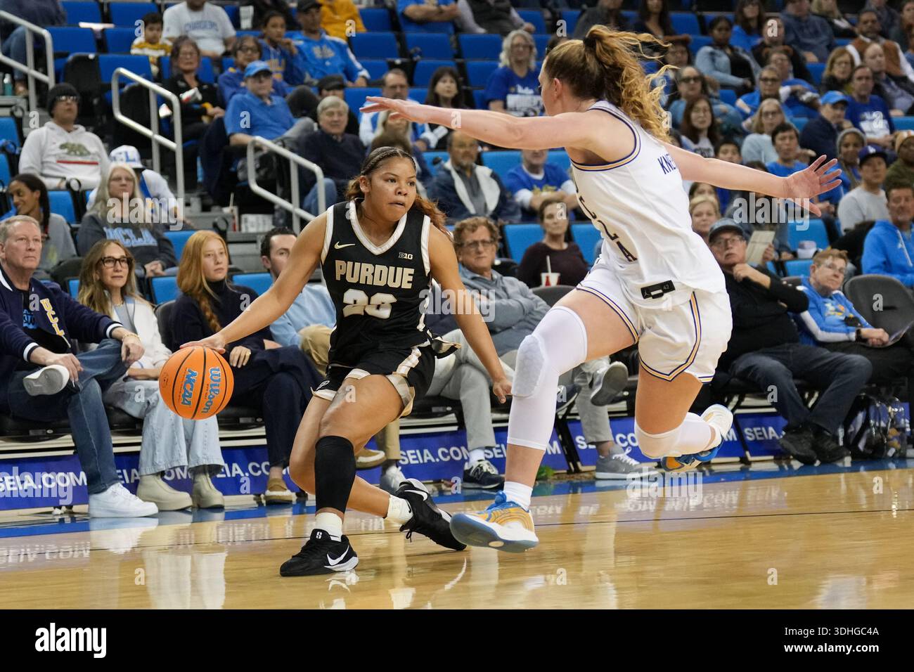 Purdue guard Kiki Smith (23) drives under pressure by UCLA guard Gianna ...