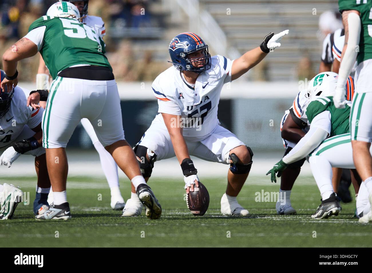 UTSA center Ben Rios (57) points to a Charlotte defender during an NCAA ...