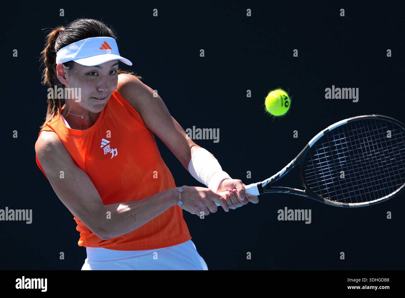 Wang Xinyu of China plays a backhand return to Jelena Ostapenko of ...