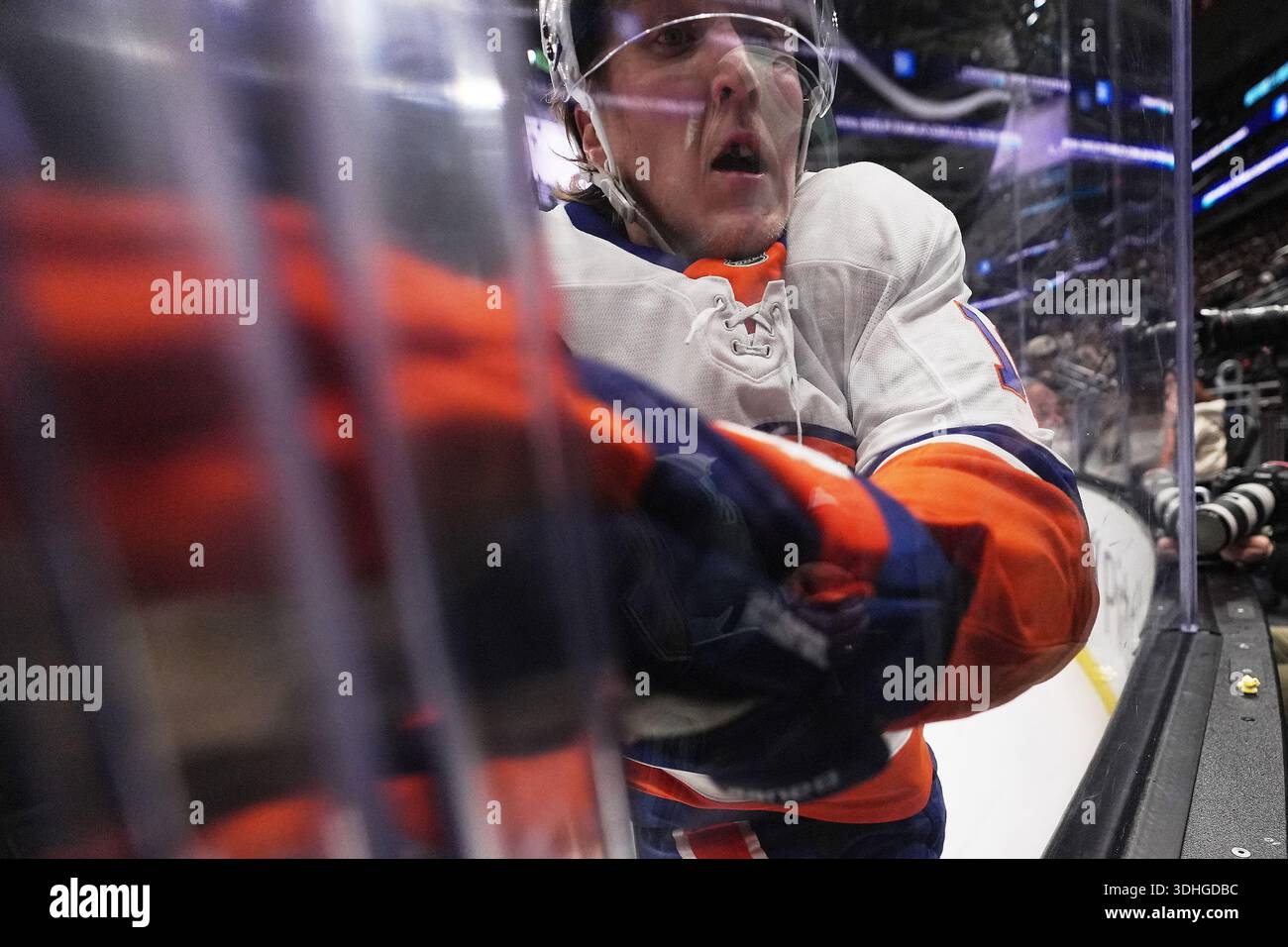 New York Islanders right wing Simon Holmstrom gets pushed against the ...