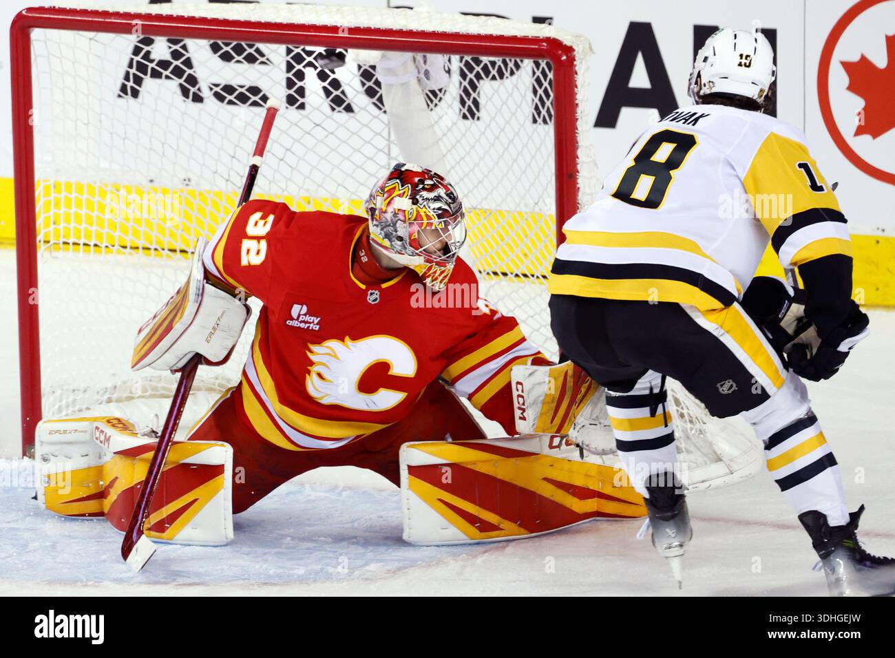 Pittsburgh Penguins' Thomas Novak, right, scores against Calgary Flames ...