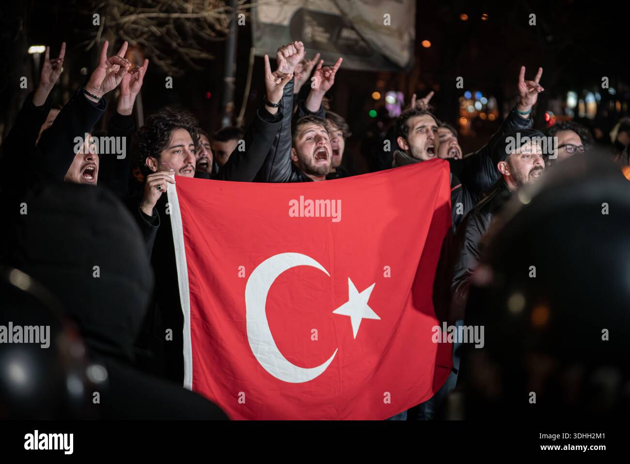 Ankara, Turkey. 21st Jan, 2026. Protesters raise the Turkish flag as ...